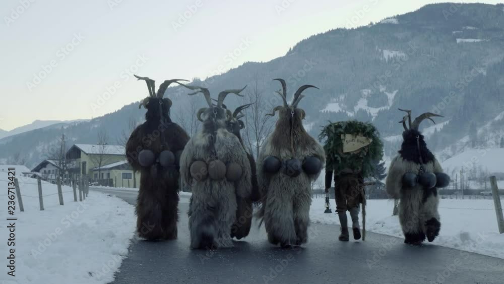 A group of Traditional Krampus walk on street in Gastein Austria ...