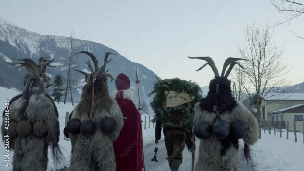 A group of Traditional Krampus from behind run in Gastein Austria ...