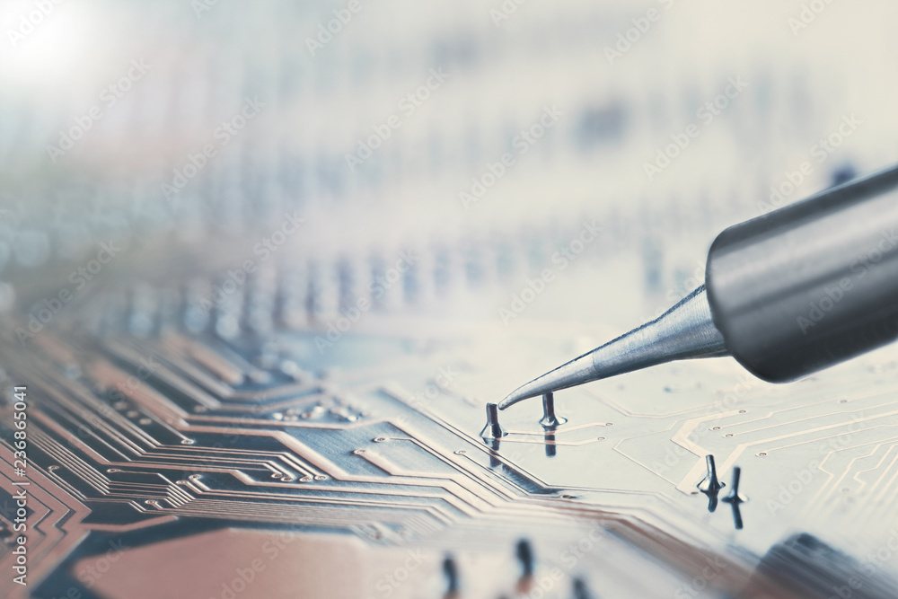 Work in progress. Soldering of electronic circuit board with electronic ...