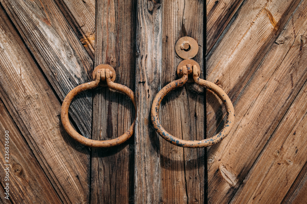 Round metal handles on closed old antique wooden gate or door Stock ...