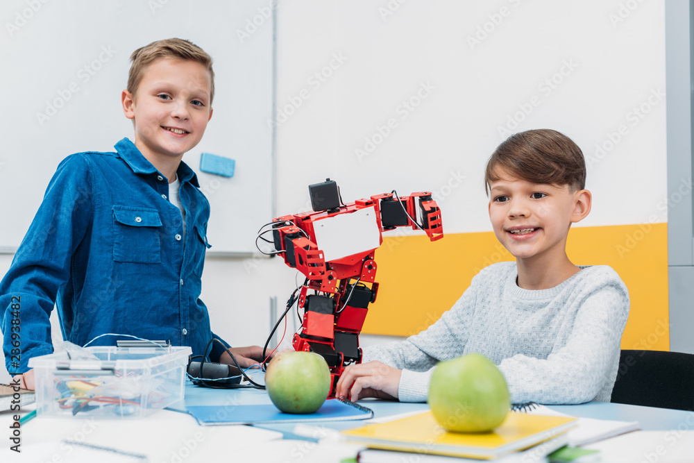 schoolboys working with robot at STEM robotics lesson Stock Photo ...