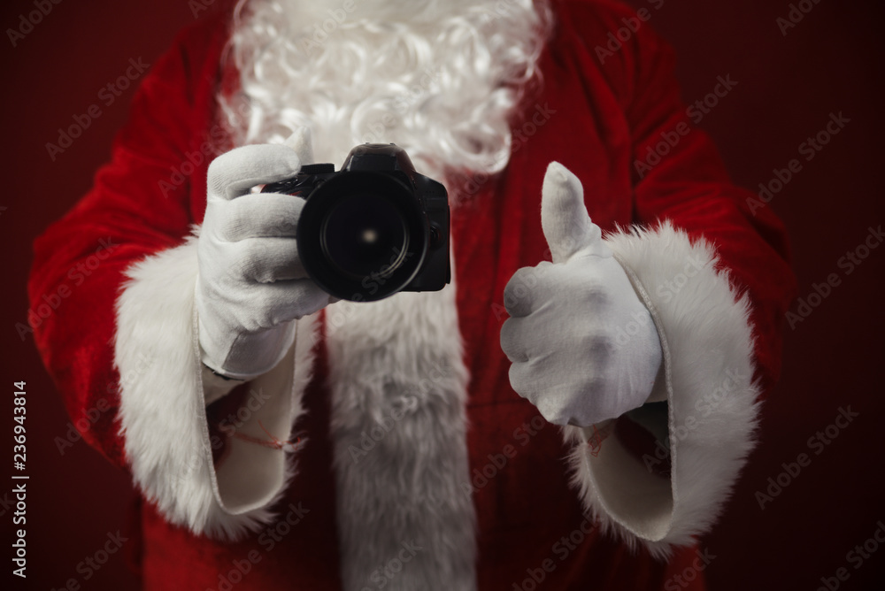 Santa Claus using DSLR camera taking images showing thumb up. Happy ...