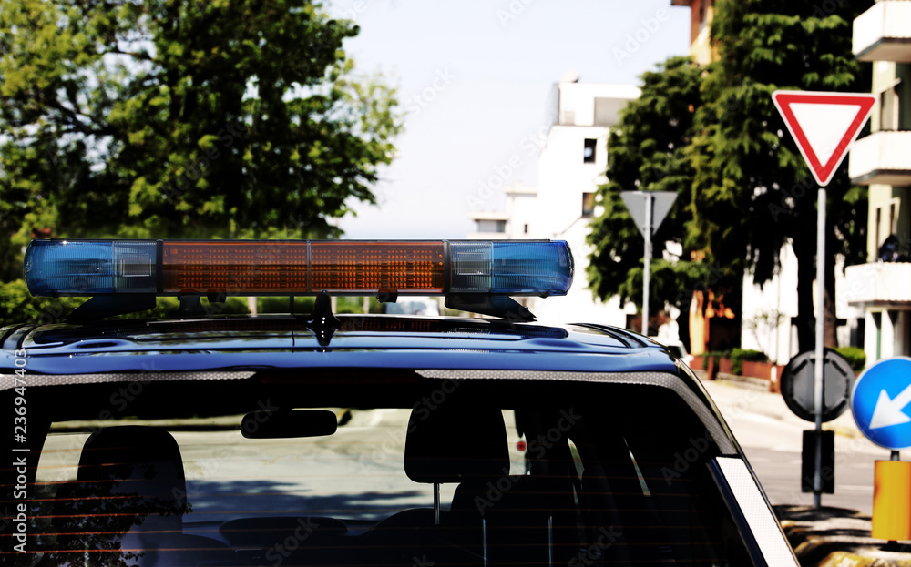 police car patrols the neighborhood of a city Stock Photo | Adobe Stock