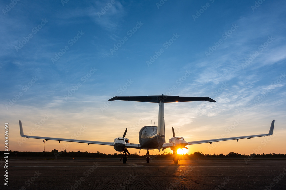Shadow of a small landed plane on the airfield and the Beautiful sunset ...