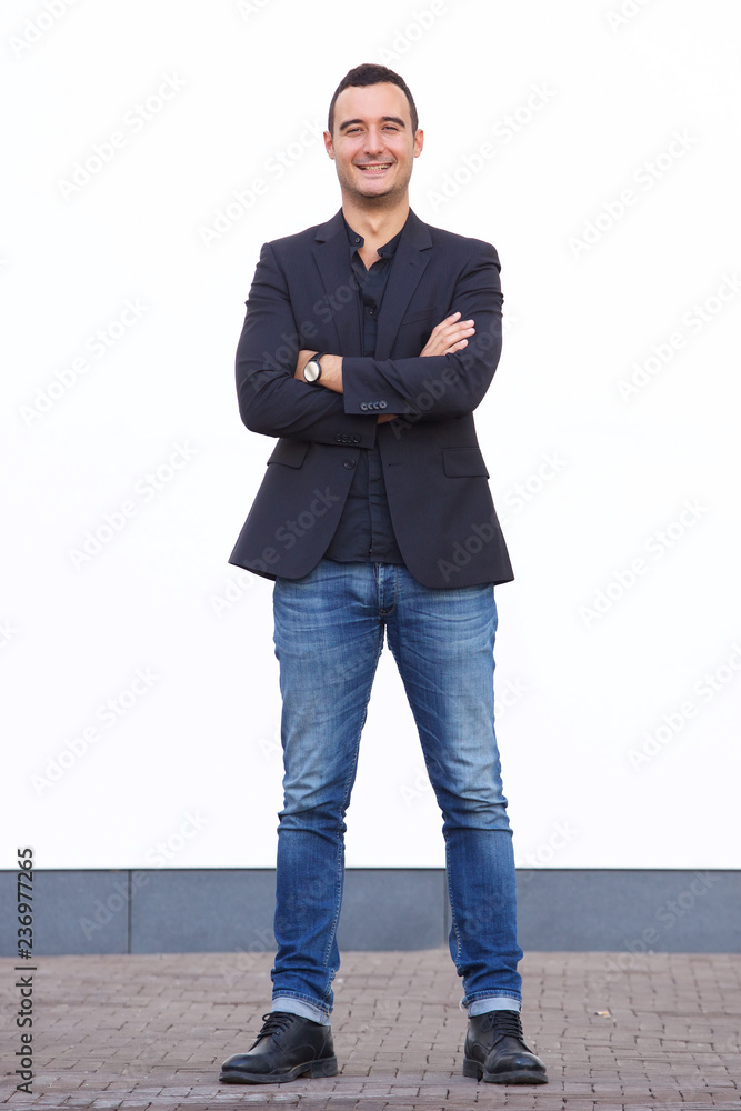 Full body confident man standing against white wall with blazer and ...