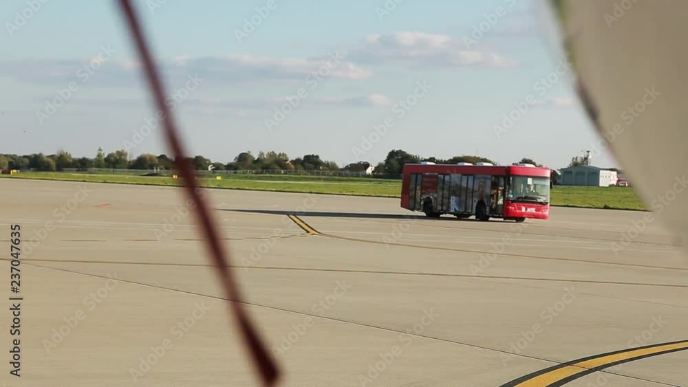 Shot an airfield track going bus cloudly sky plane transportation ...