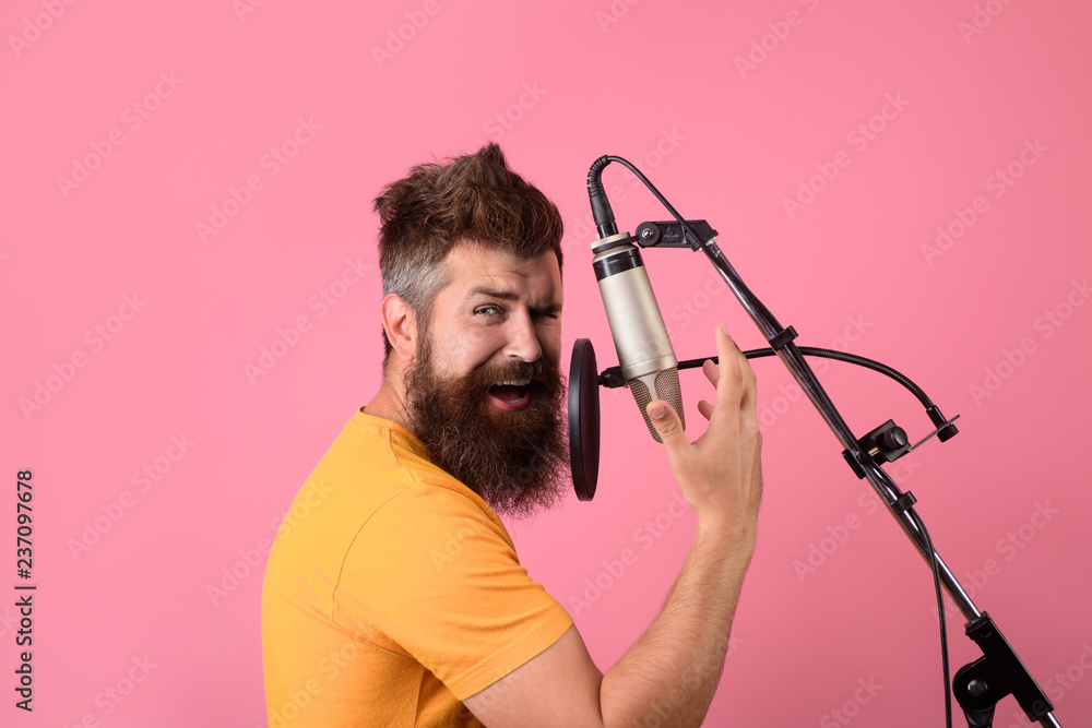 Brutal bearded guy singer with microphone on stage. Concert&music ...