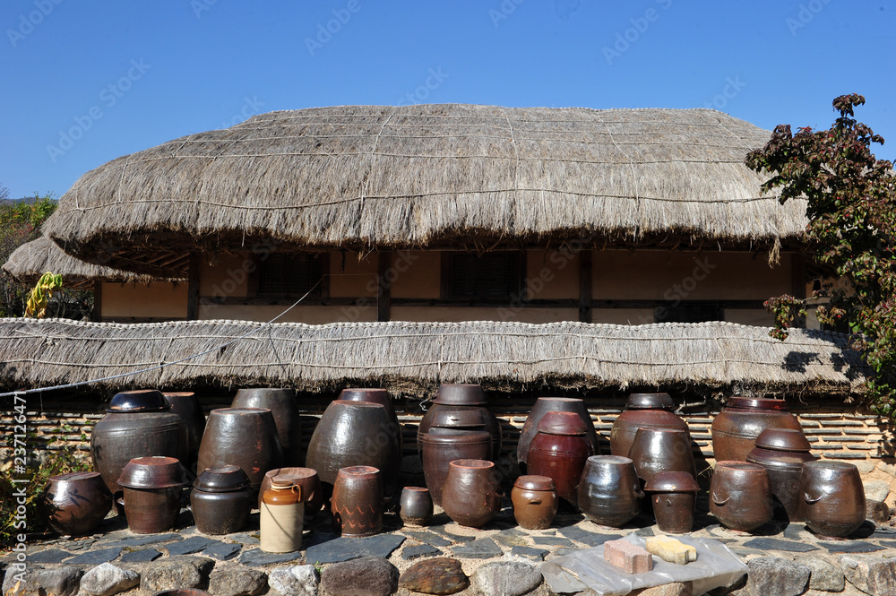 Korean thatched-roof house and platform for crocks of sauces and ...