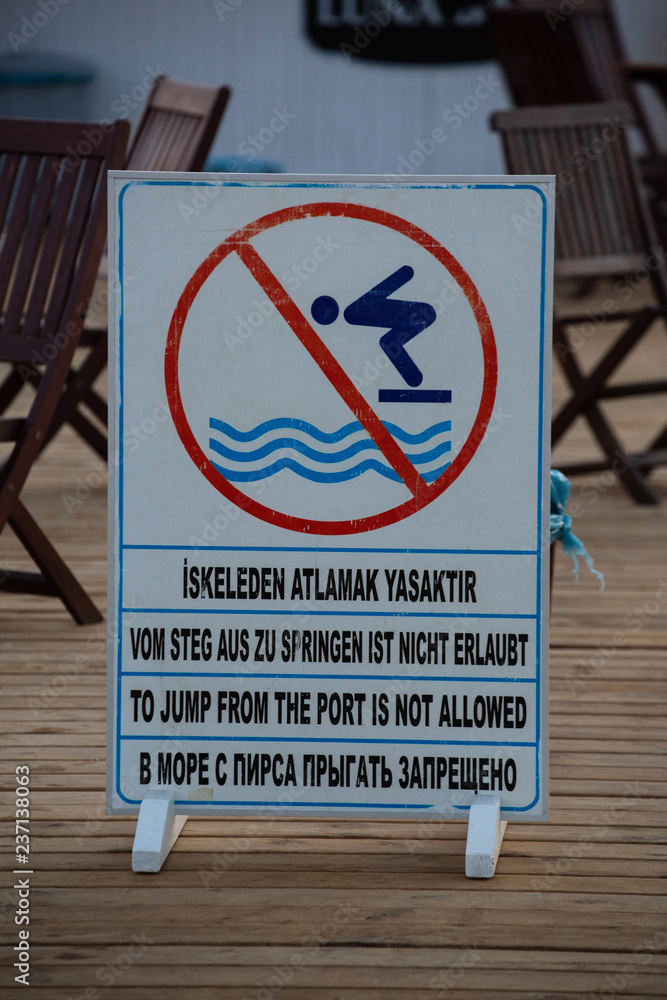 Warning Sign No Diving on a Pier. Cafe on a background Stock Photo ...