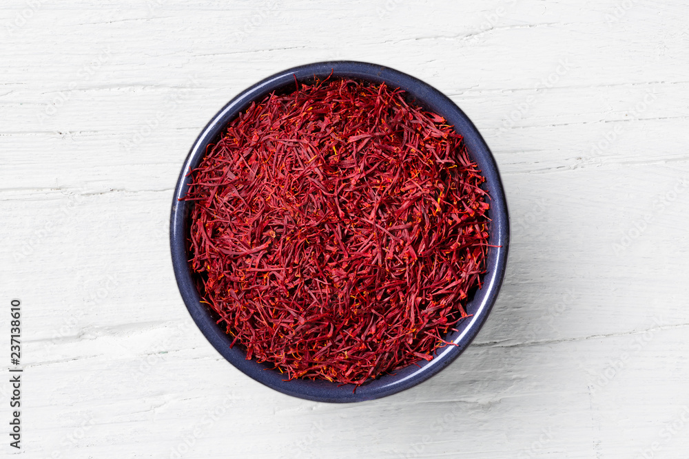 Saffron threads on white wooden background Stock Photo | Adobe Stock