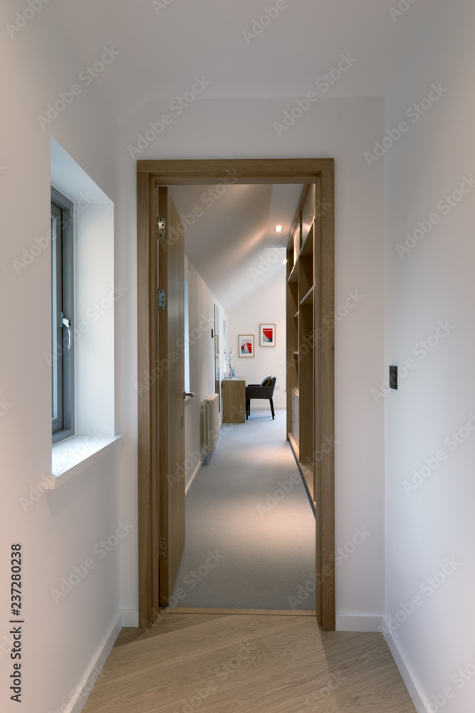 Evening view through an open door into the bedroom of a modern house ...