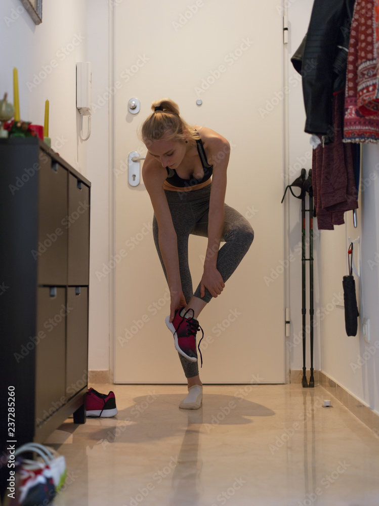 Woman taking off sneakers Stock Photo | Adobe Stock