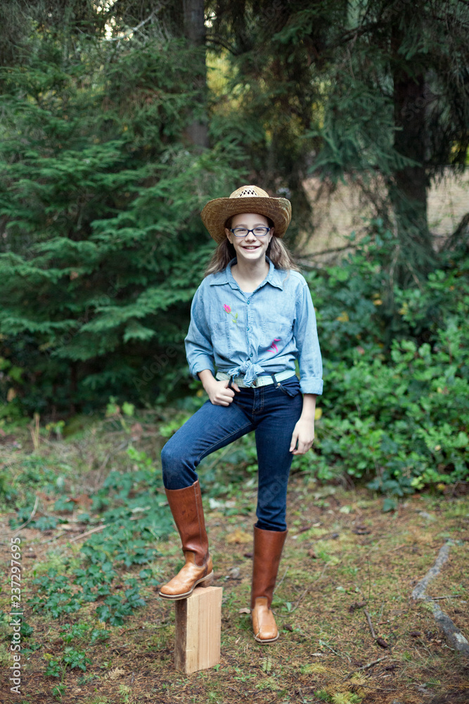 Preteen girl poses in her costume for cowboy day of spirit week at her ...