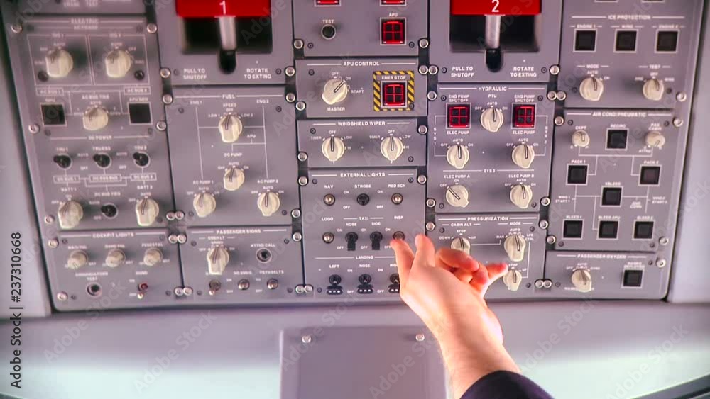Pilot inside the cockpit of the plane pressing button on the control ...
