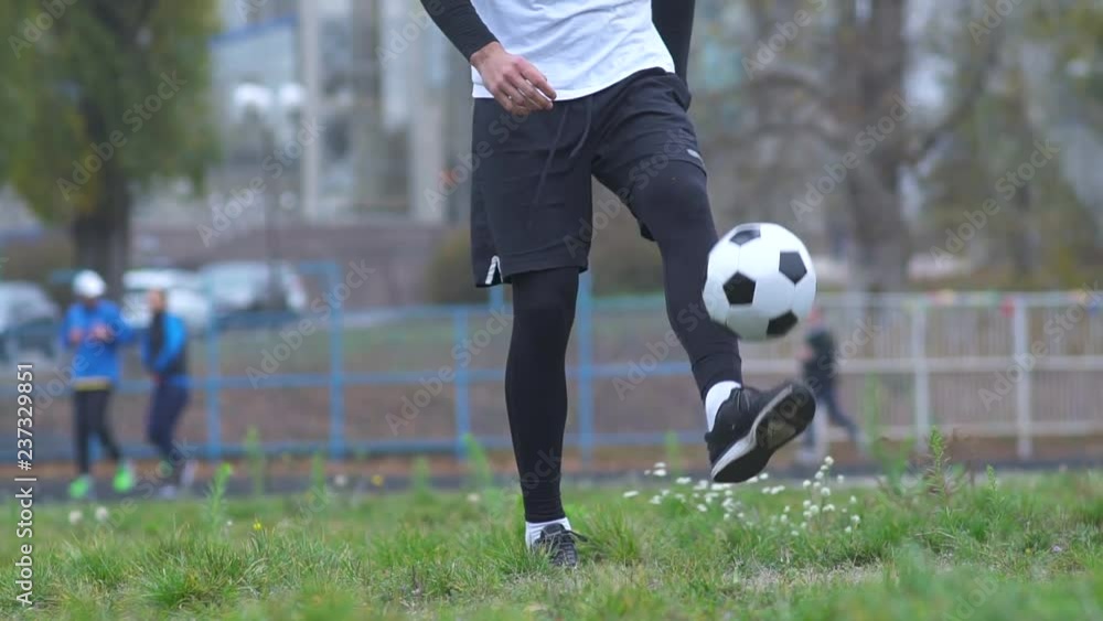 Video „Male feet playing with a soccer ball outdoors. The legs of a man ...