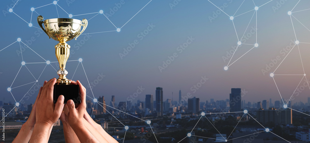 Winning team raise trophy cup with digital background, digital ...