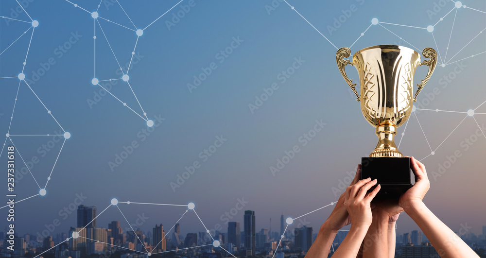 Winning team raise trophy cup with digital background, digital ...