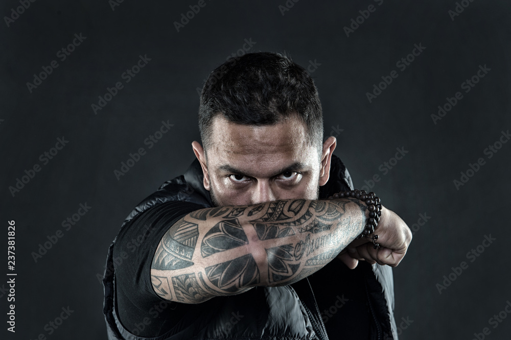 Tattooed elbow hide male face. Masculinity and brutality. Tattoo ...