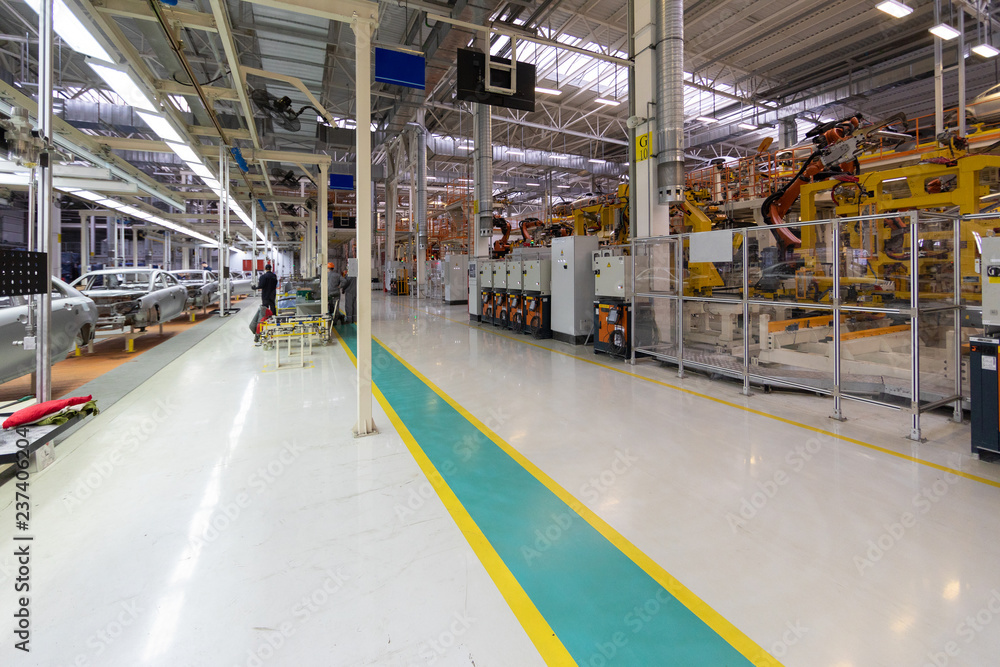 Workers assemble a vehicle body. process of welding cars. Modern ...