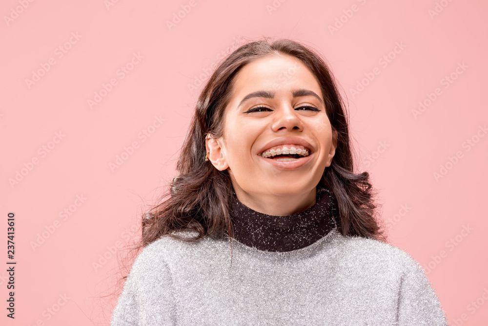 Happy business woman standing and smiling isolated on pink studio ...