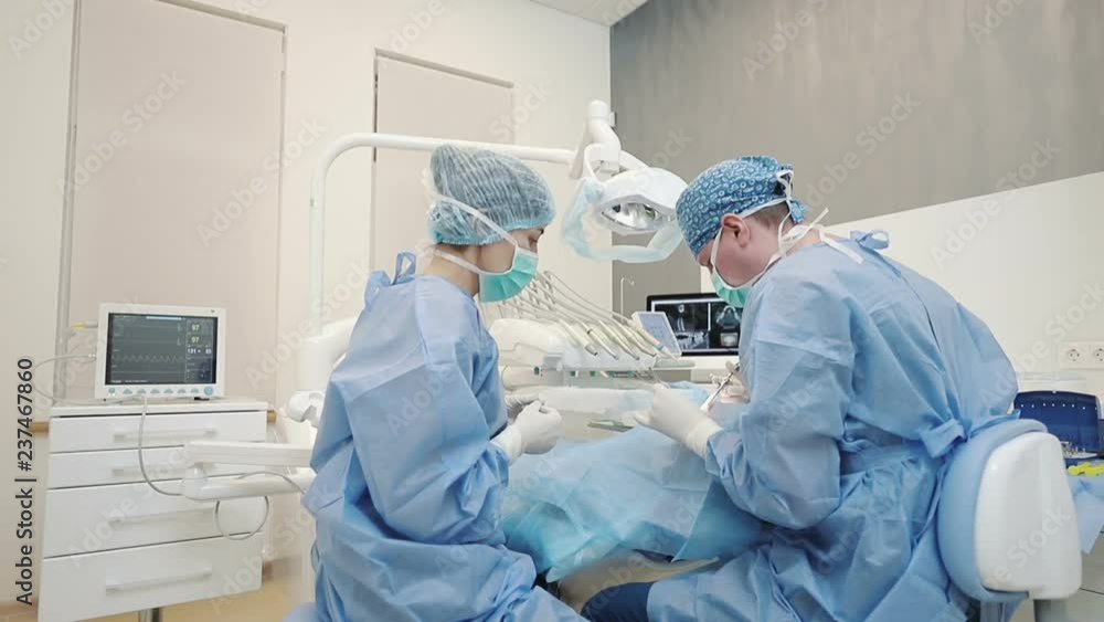 Dentist makes an anesthetic injection of anesthesia to the patient in ...