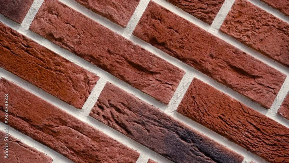 Rotation of red decorative brick with cracks. Brickwork background ... Rotation of red decorative brick with cracks. Brickwork background ...