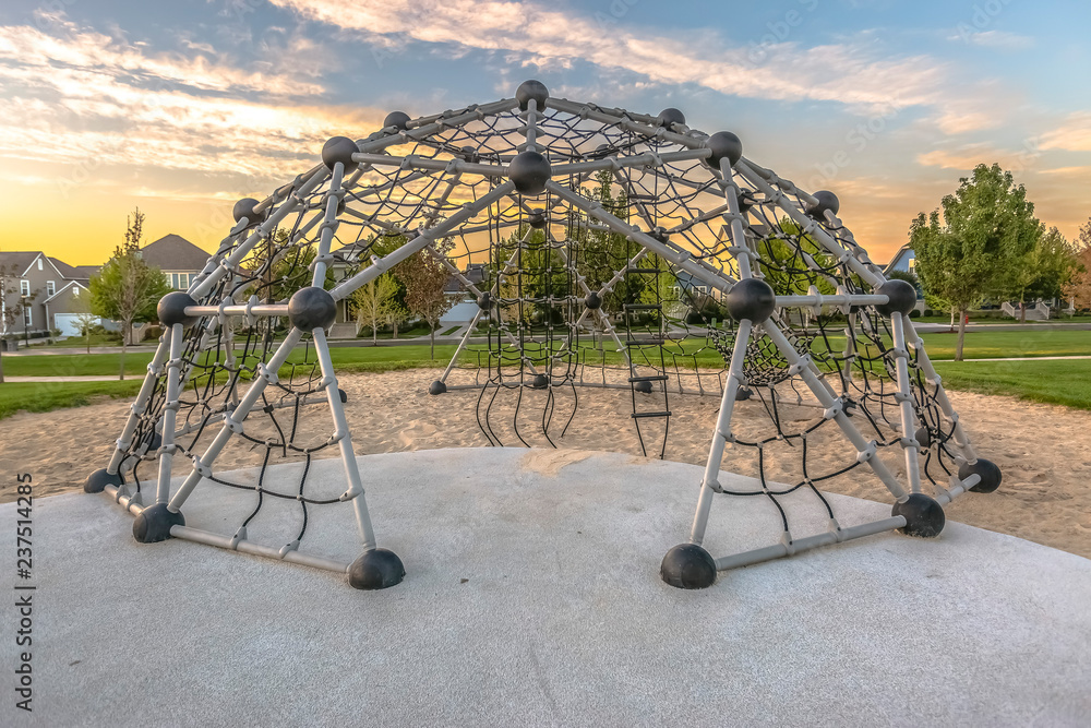 Dome climbing frame with rope ladder in the center Stock Photo | Adobe ...