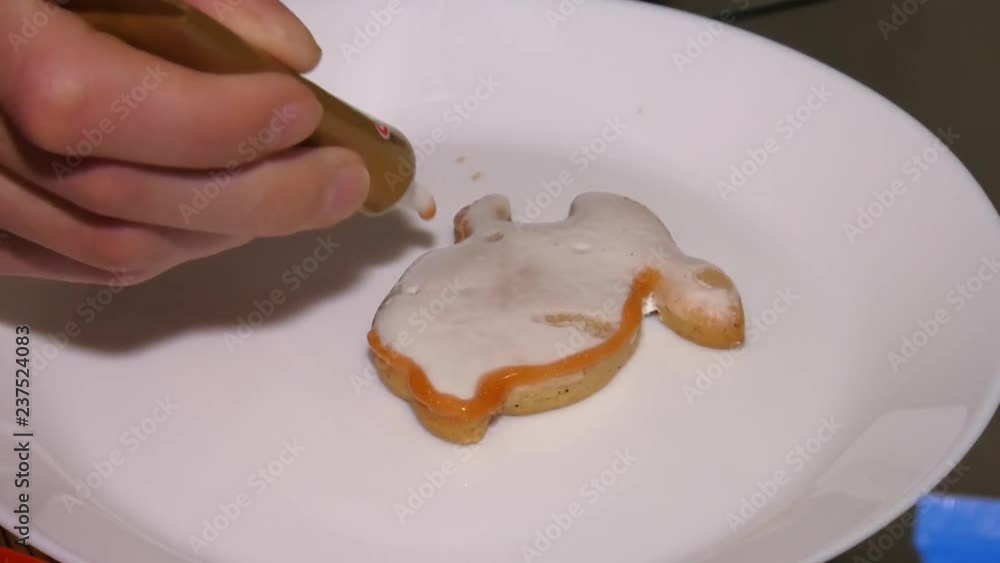 Preparing homemade cookies. Womans hand decorating cookies with sugar ...