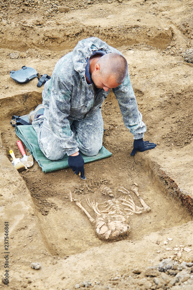 Archaeological excavation. The archaeologist in a digger process ...
