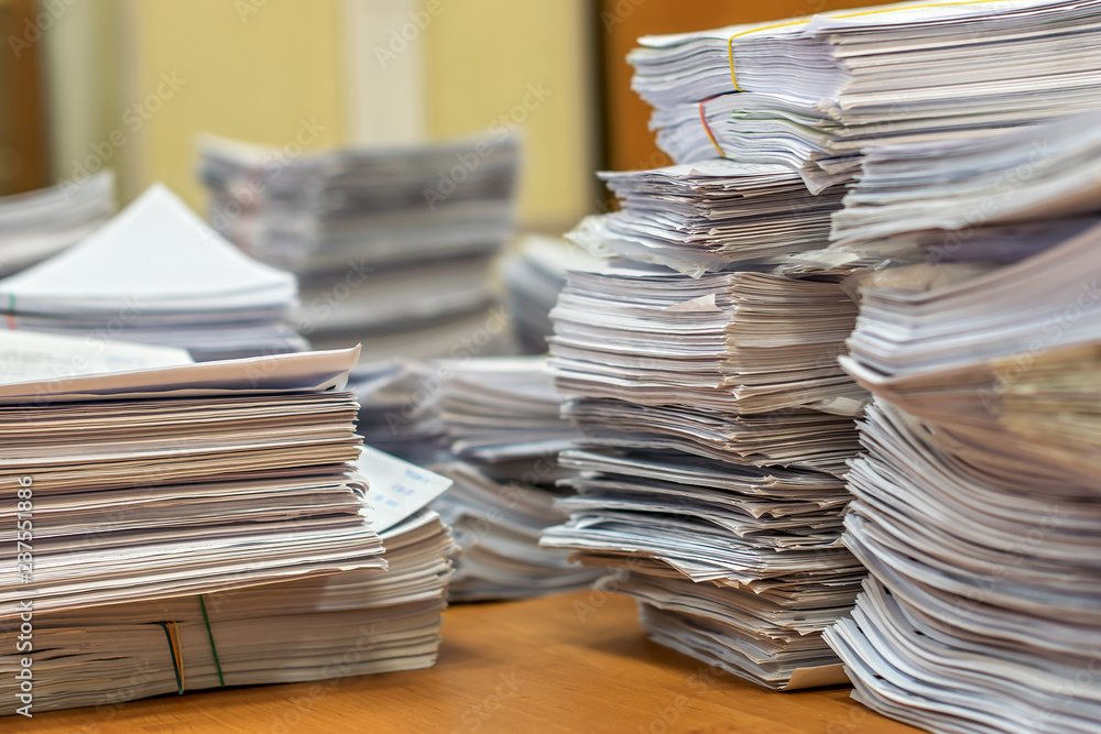 bundles bales of paper documents. stacks packs pile on the desk in the ...