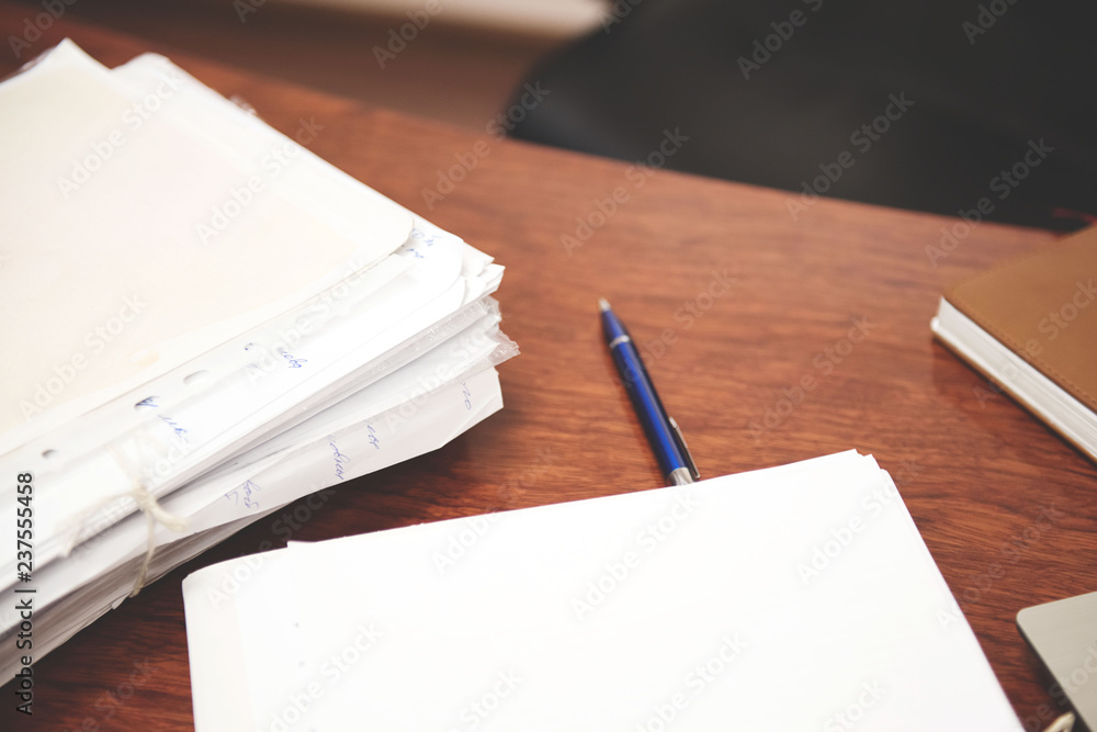 Pile of unfinished documents on office desk, Stack of business paper. A ...