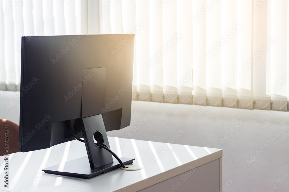 back side of monitor on desktop with window sun light.Image with copy ...