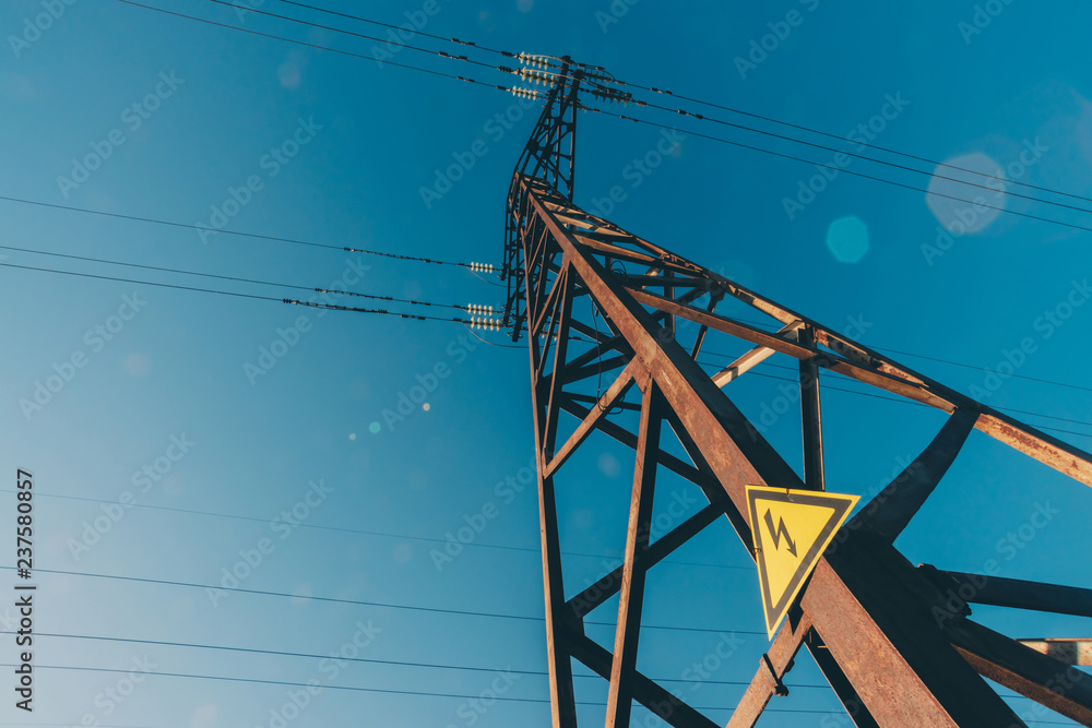 Power lines on background of blue sky close-up. Electric hub on pole ...