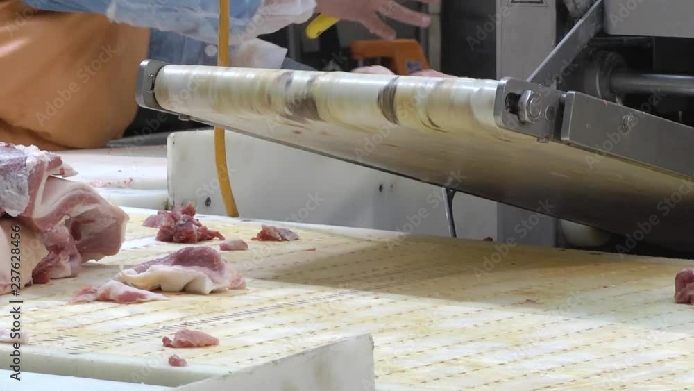 Meat industry. boning pork carcasses. butcher cuts pork carcasses in a ...