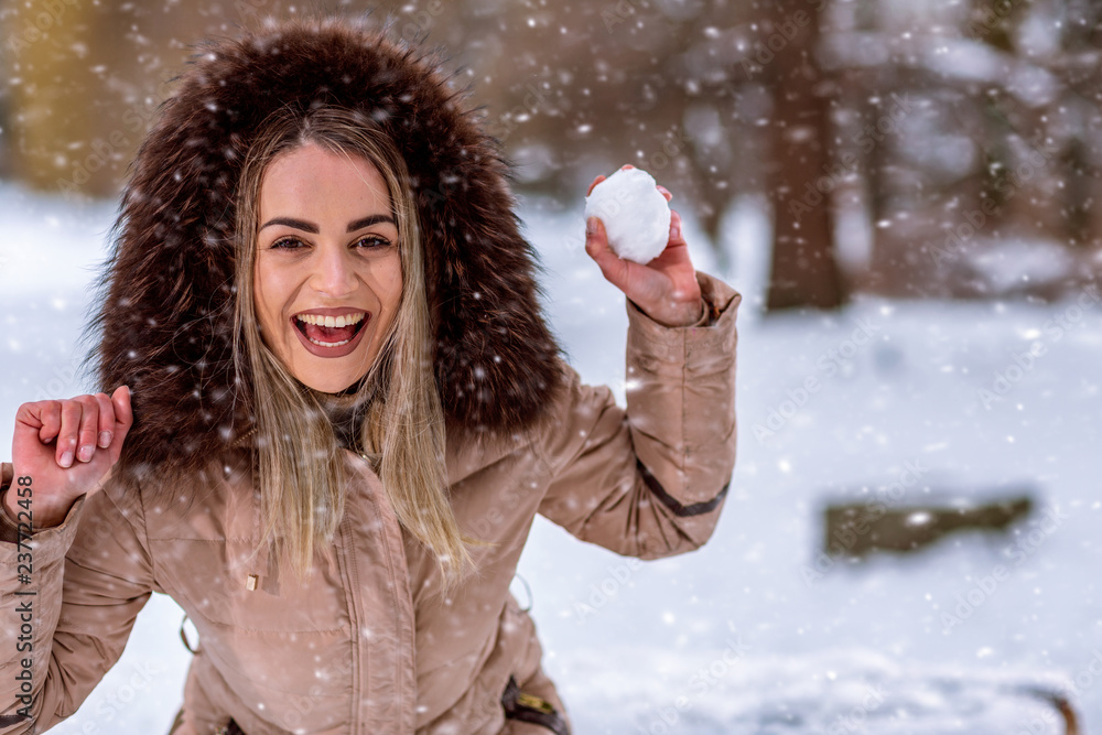 Happy girl playing snowball fight on the winter snow day. Stock Photo ...