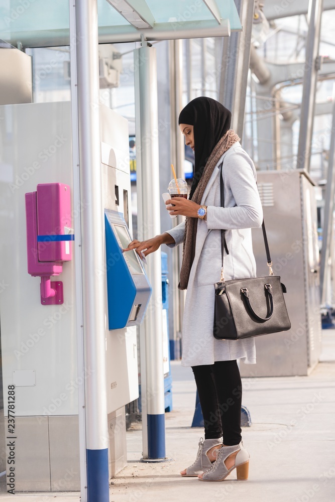 Hijab woman using ticket vending machine at railway station Stock Photo ...