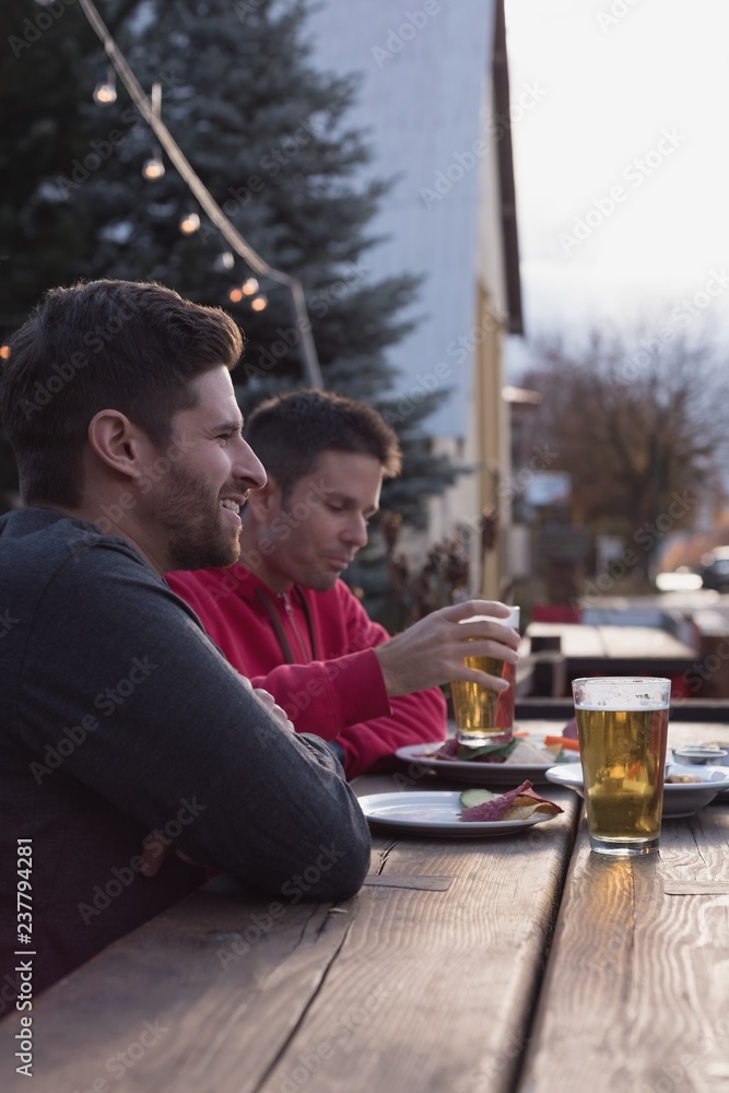Friends enjoying their drinks at outdoor pub Stock Photo | Adobe Stock