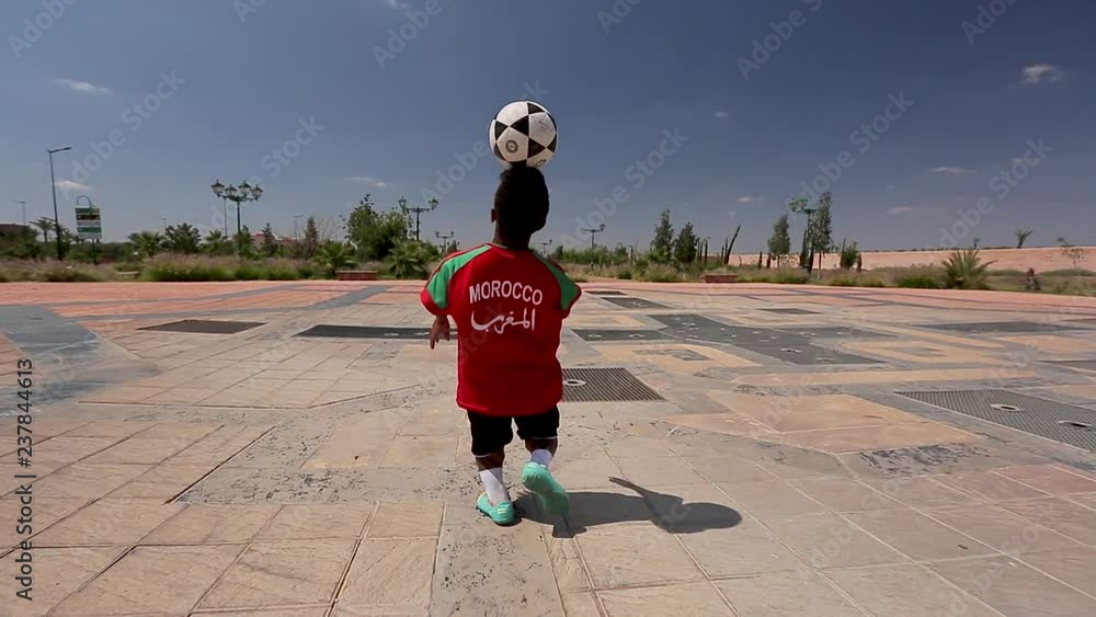A Midget soccer player wearinga football jersey of the Moroccan ...