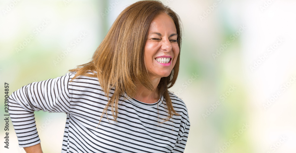 Beautiful middle age woman wearing stripes sweater over isolated ...