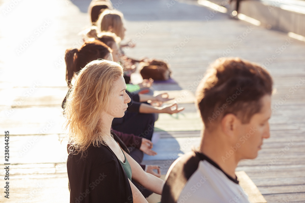 fitness, yoga and healthy lifestyle concept - group of people doing ...