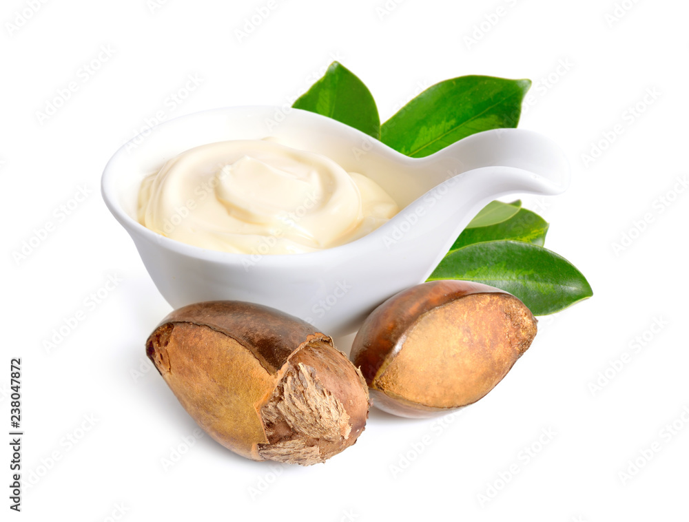 Shea nuts with butter or cream in the bowl. Isolated on white ba Stock ...