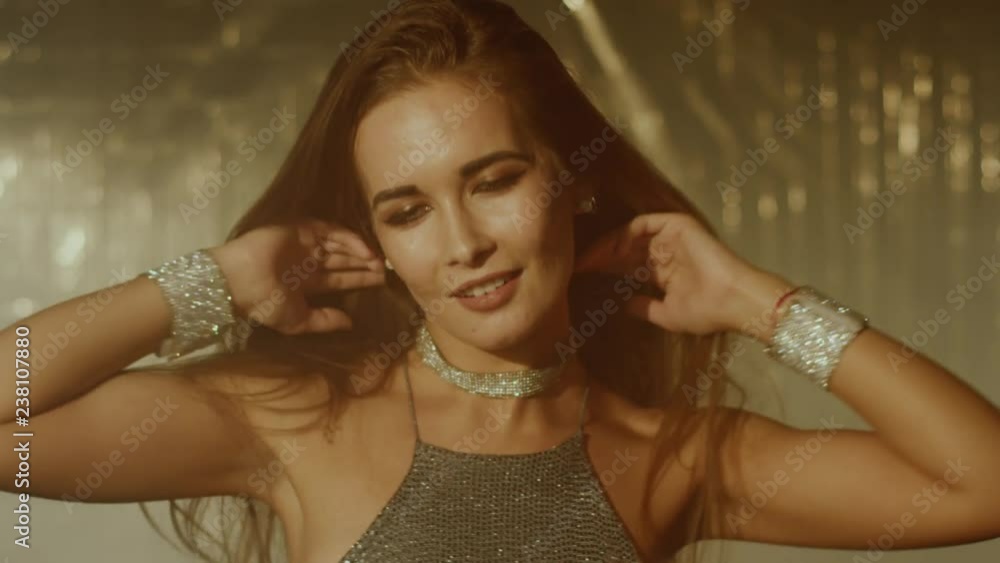 Beautiful girl dancer is moving hands on a dance floor in nightclub ...