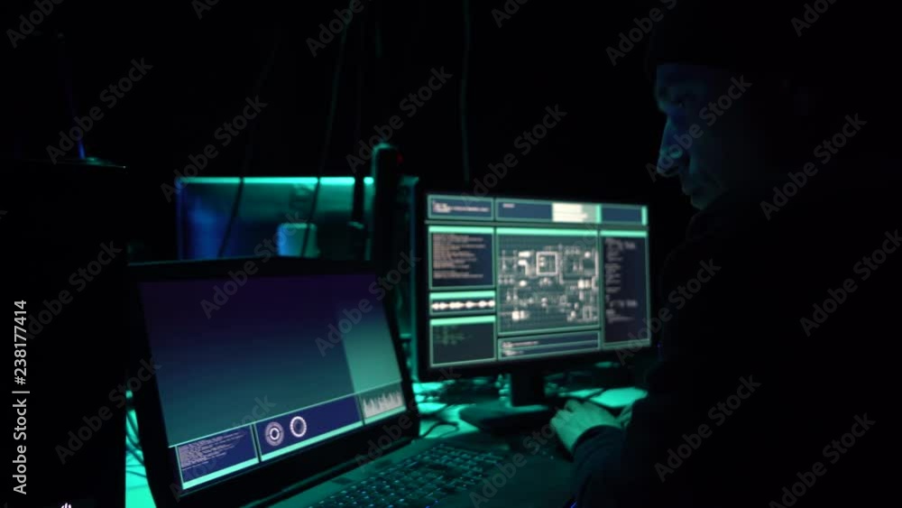 Wanted hackers coding virus ransomware using laptops and computers in the basement. Cyber attack ...