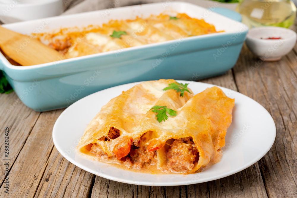 Cannelloni with filling of ground beef, tomatoes, baked with bechamel ...