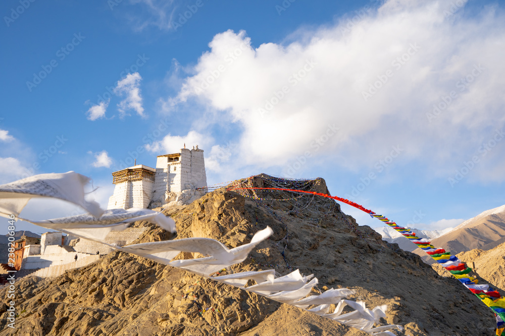 Monastery on the top of mountain hill with white prayer tibetan flags ...