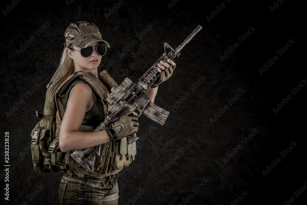 Sexy girl wearing military style posing with guns and sunglases ...