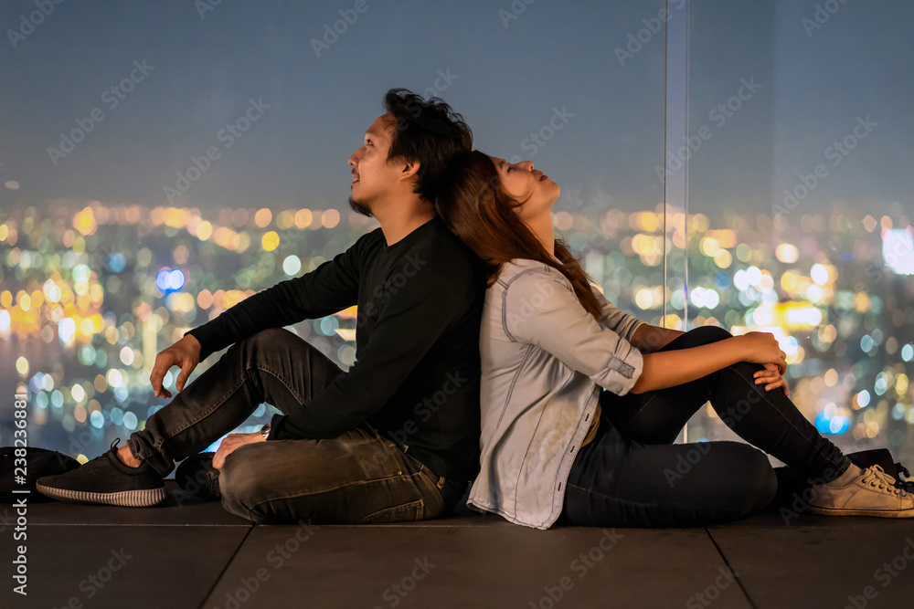 Romantic Couple Sitting on the rooftop from bangkok modern building at ...