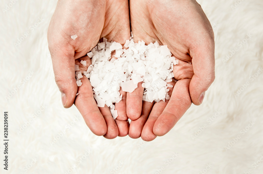 Close up view of man hands holding Magnesium Chloride vitamin salt ...