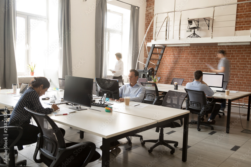 Serious diversity team of focused employees working online project in ...