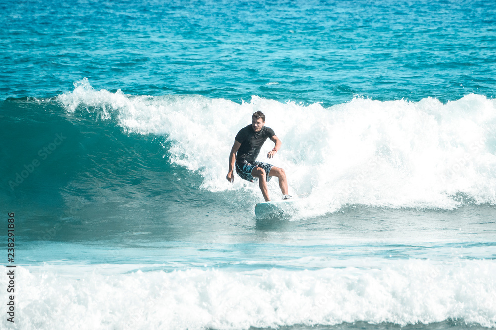 surfer on a shortboard riding a wave in the ocean Stock Photo | Adobe Stock